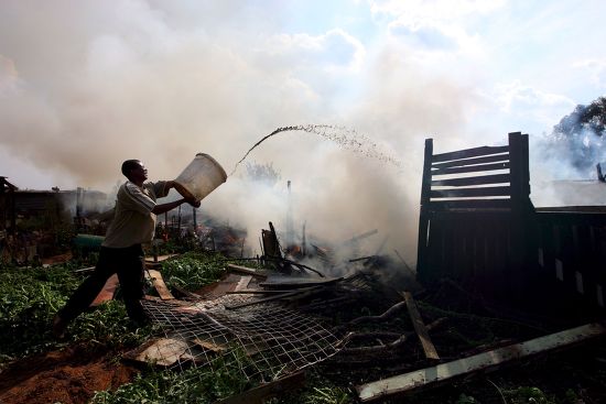 Man Treis Extinguish Burning Shack During Editorial Stock Photo - Stock ...
