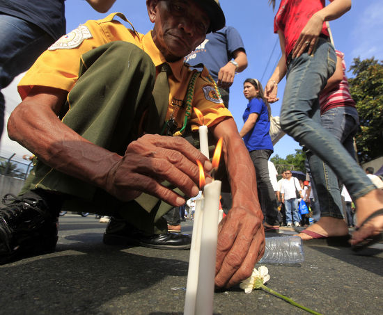 Filipino Traffic Enforcer Lights Candle During Editorial Stock Photo ...