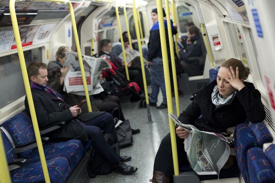 Commuter Reads Newspaper On Train Tube Editorial Stock Photo - Stock ...