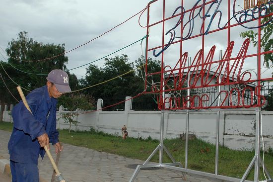 Sweeper Cleans Street Beside Neon Sign Editorial Stock Photo - Stock ...