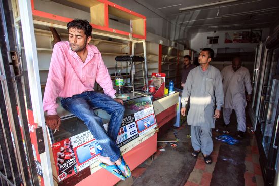 Pakistani Shop Owner Sits Inside His Editorial Stock Photo - Stock ...