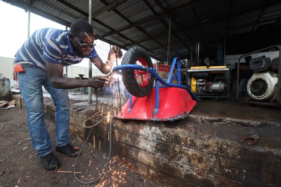 Man Welding Rod On Wheel Barrow Editorial Stock Photo - Stock Image ...