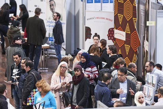 Visitors Walk Between Exhibition Stands During Editorial Stock Photo ...