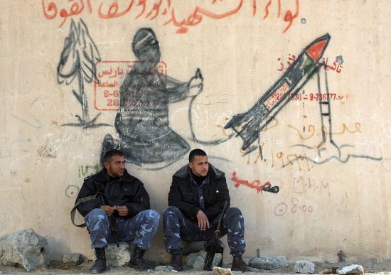 Palestinian Security Guards Sit Underneath Graffiti Editorial Stock ...