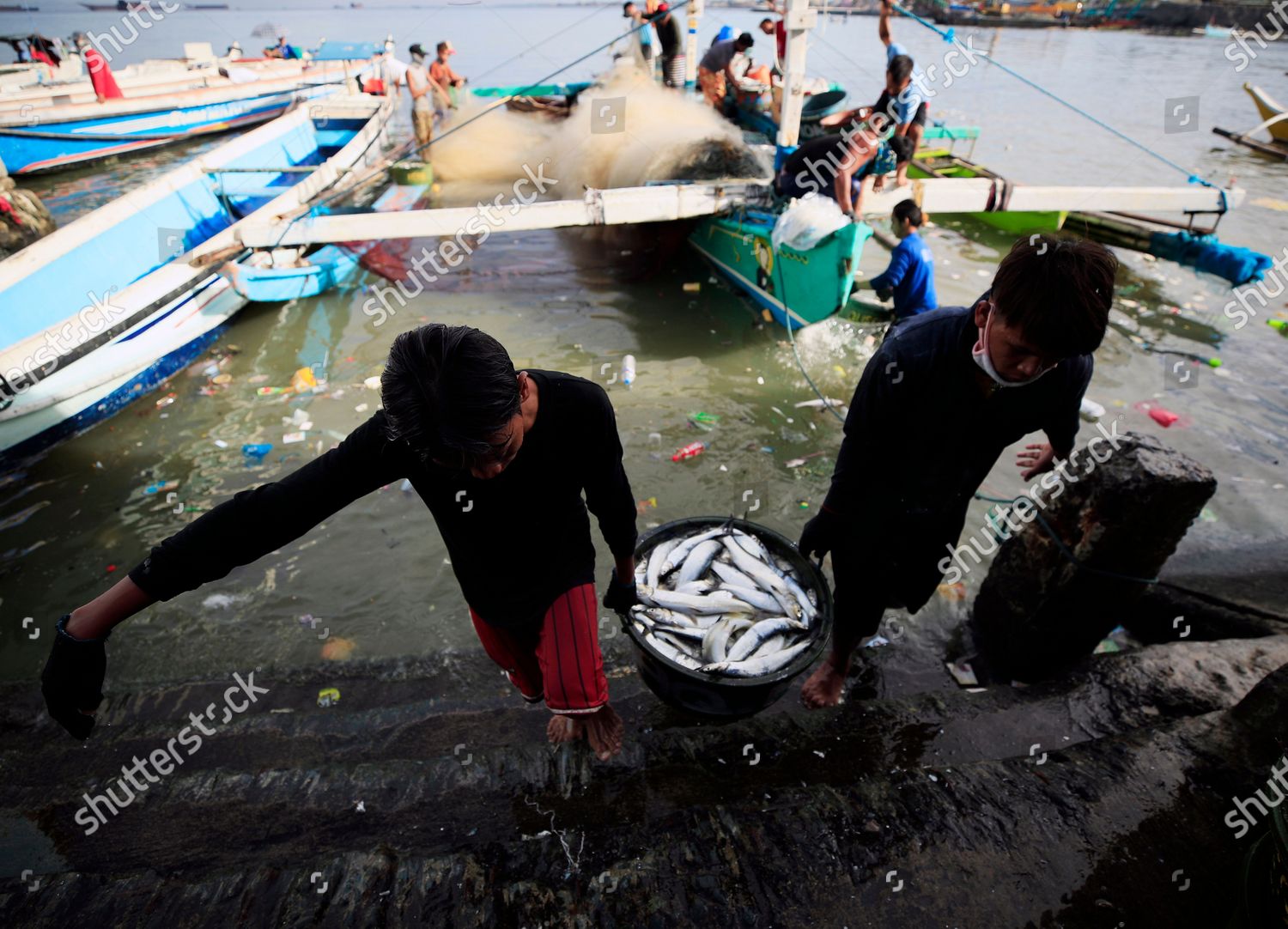 FILIPINO FISHERMEN CARRY FISH ON CONTAINER Editorial Stock Photo ...