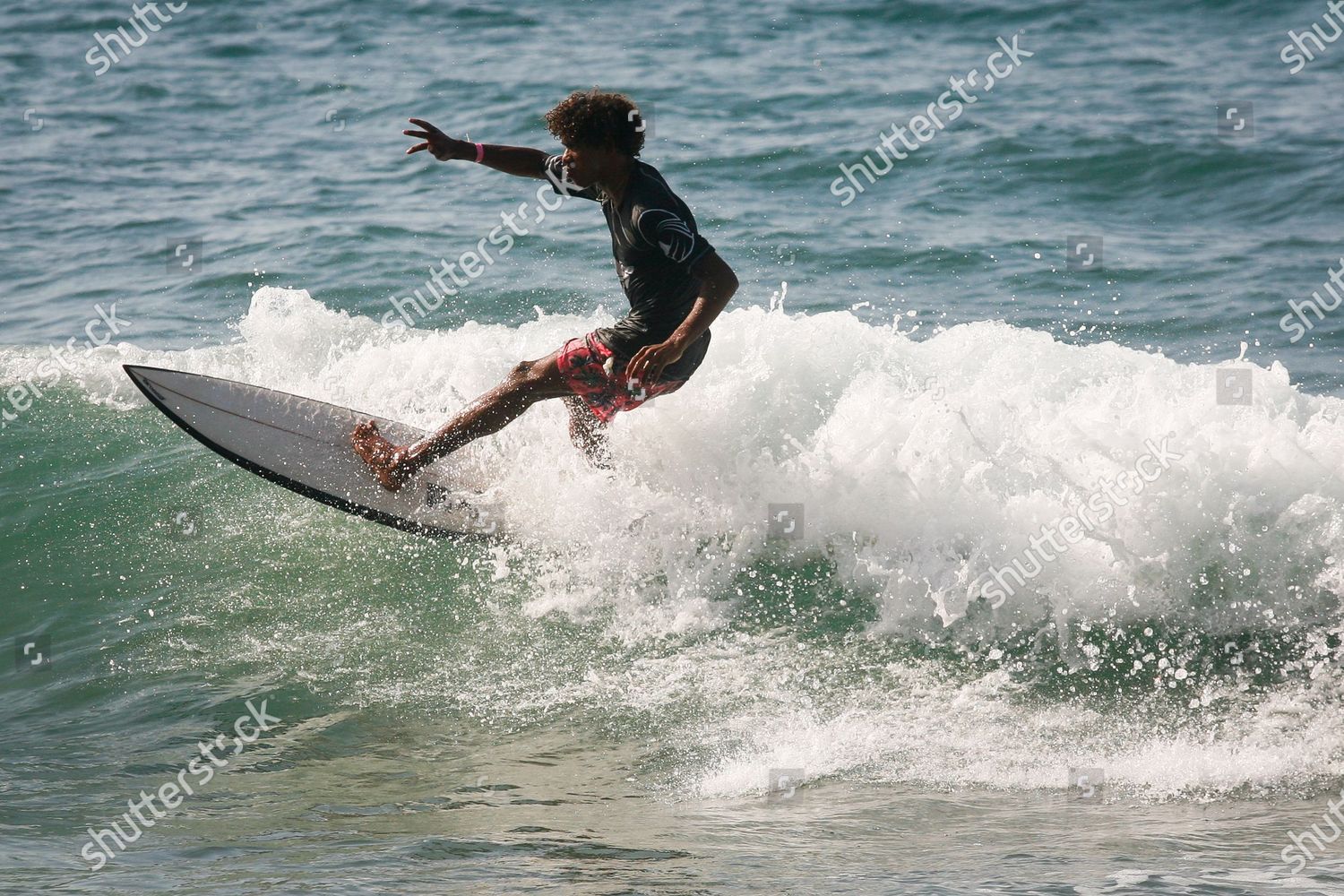 Surfer Maneuvers Over Wave During First Editorial Stock Photo - Stock ...