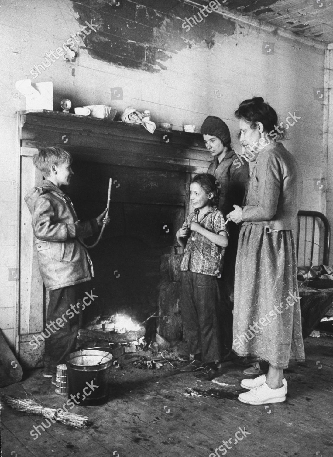 Poverty Stricken Family Huddled Around Fireplace Editorial Stock Photo ...