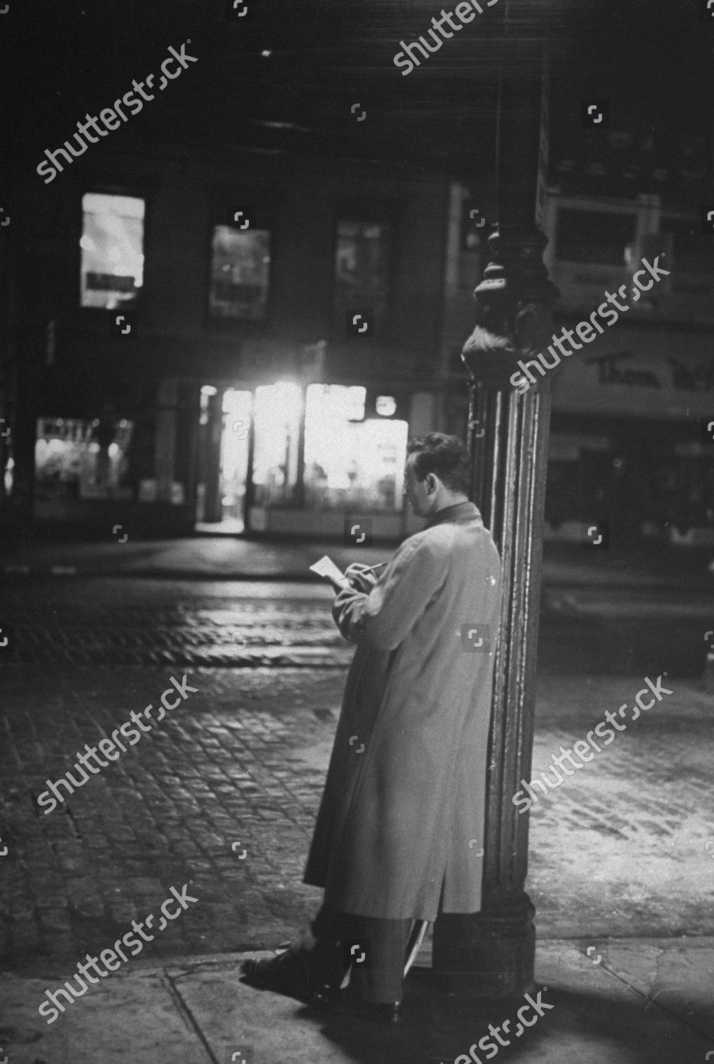 Man Leaning Against Lamp Post Reading Editorial Stock Photo - Stock ...