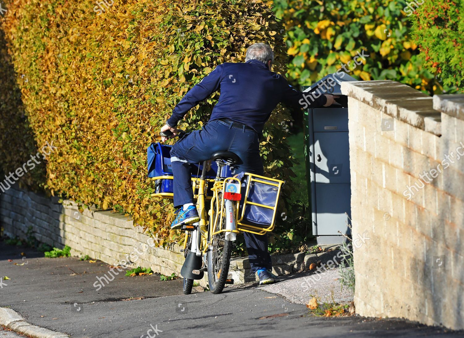 Letter Carrier On Postal Bike Distributes Editorial Stock Photo - Stock ...