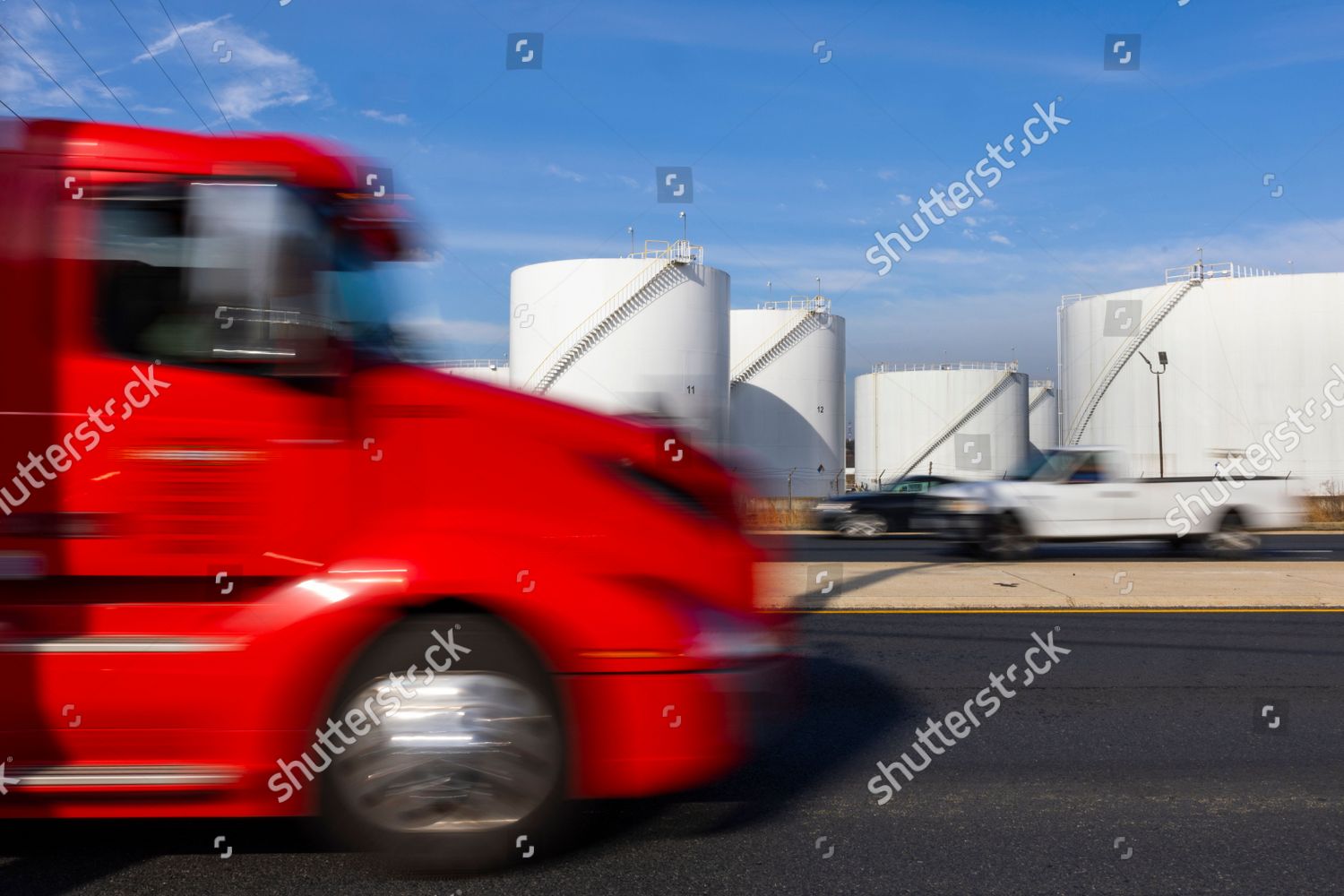 TRAFFIC PASSES FUEL STORAGE TANKS HOLDING Editorial Stock Photo - Stock ...