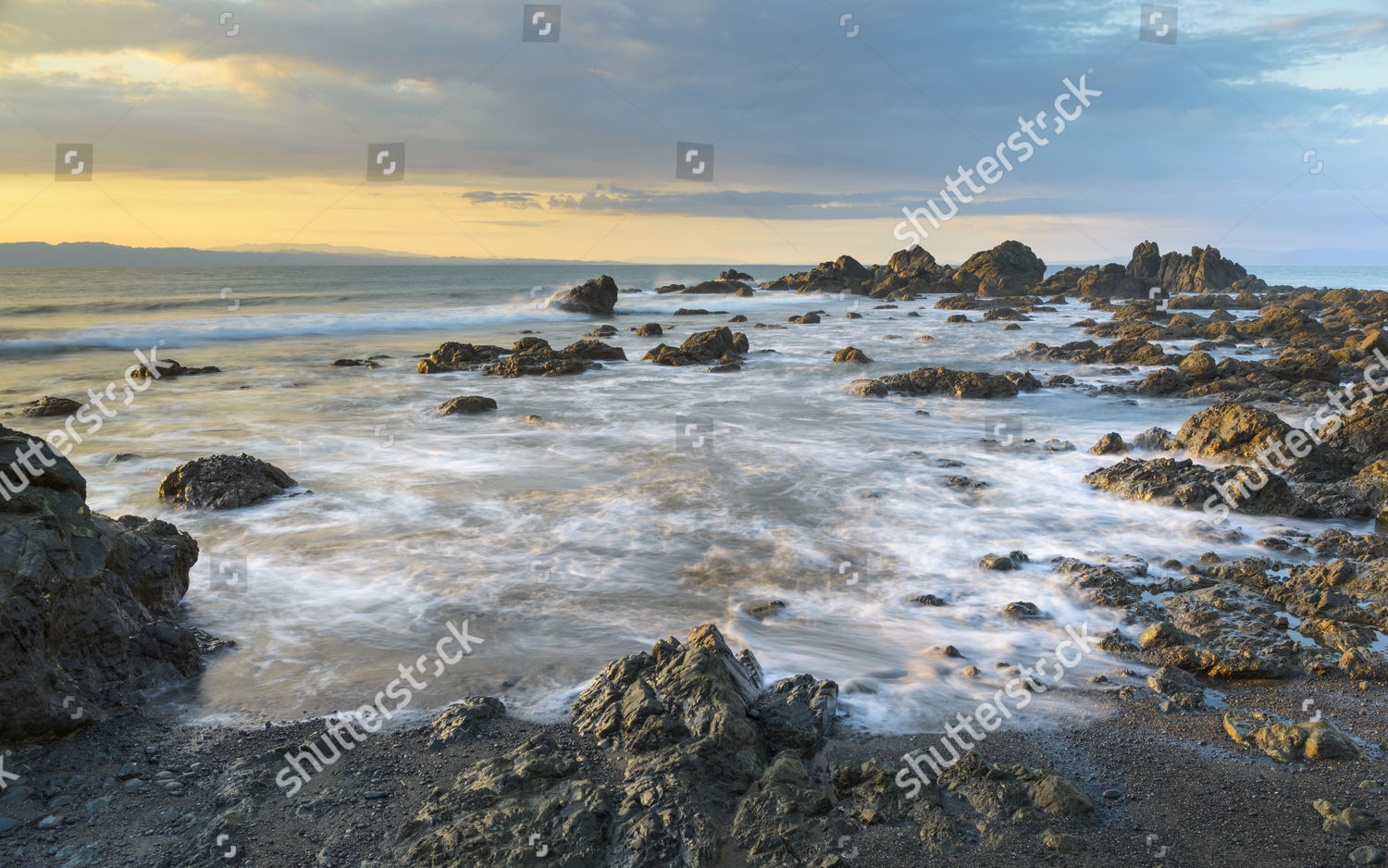 Water Washing Over Rocks On Beach Editorial Stock Photo - Stock Image ...