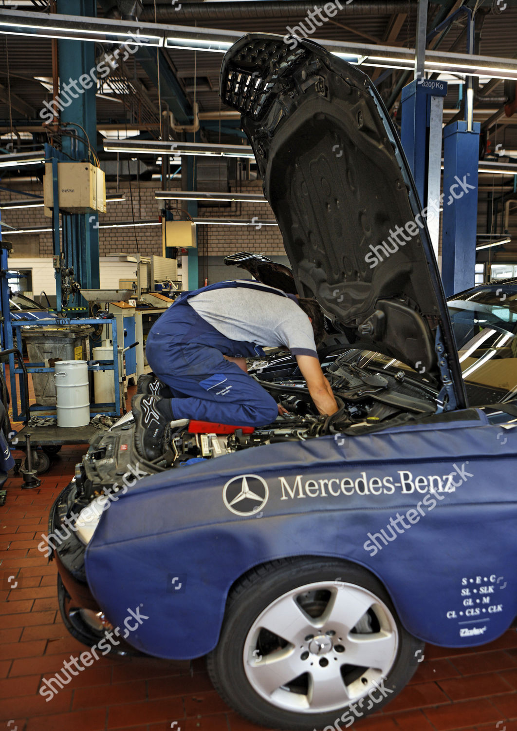 Mechanic Kneeling On Engine Block Sclass Editorial Stock Photo - Stock ...