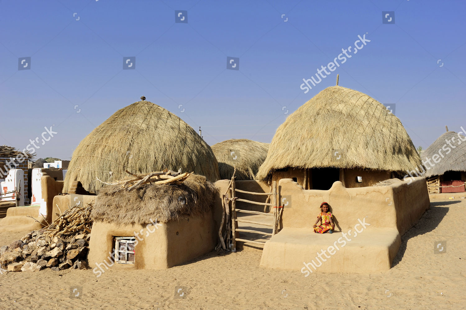 LITTLE GIRL SITTING ON ADOBE BENCH Editorial Stock Photo - Stock Image ...