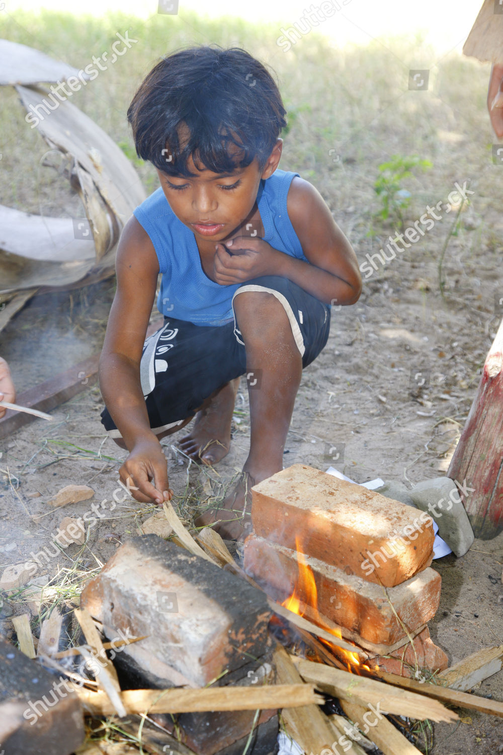 Boy Lighting Fire Cooking On Hearth Editorial Stock Photo - Stock Image ...