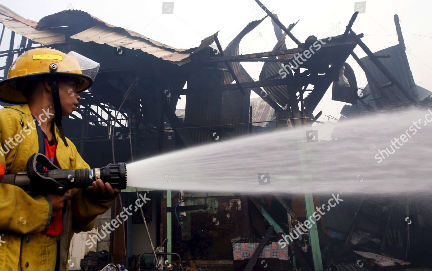 Filipino Firefighter Extinguishes Fire Amid Burned Editorial Stock ...