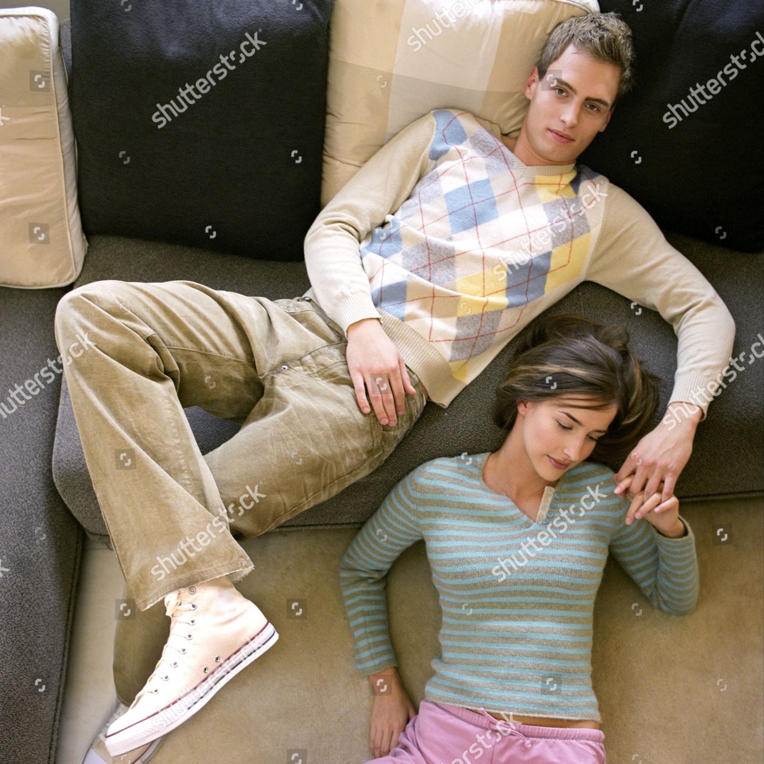 Fashionable Young Couple Lounging On Couch Editorial Stock Photo ...