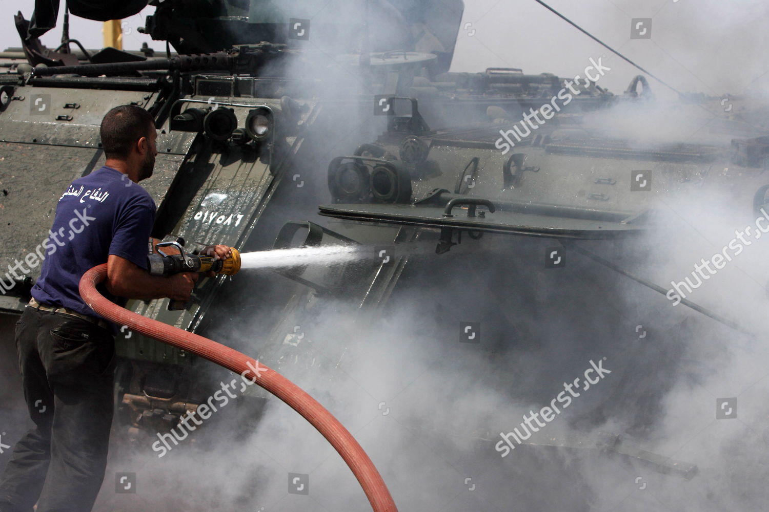 Lebanese Civil Defense Worker Extinguishes Burning Editorial Stock ...
