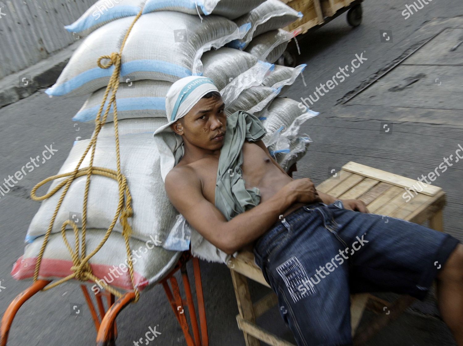 Filipino Worker Rests Beside Cart Full Editorial Stock Photo - Stock ...