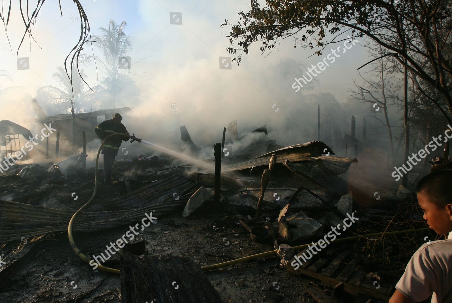 Filipino Firefighter Directs Waterhose Toward Burned Editorial Stock ...