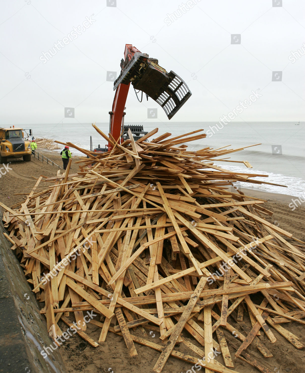 Digger Piles Wood On Beach Editorial Stock Photo - Stock Image ...