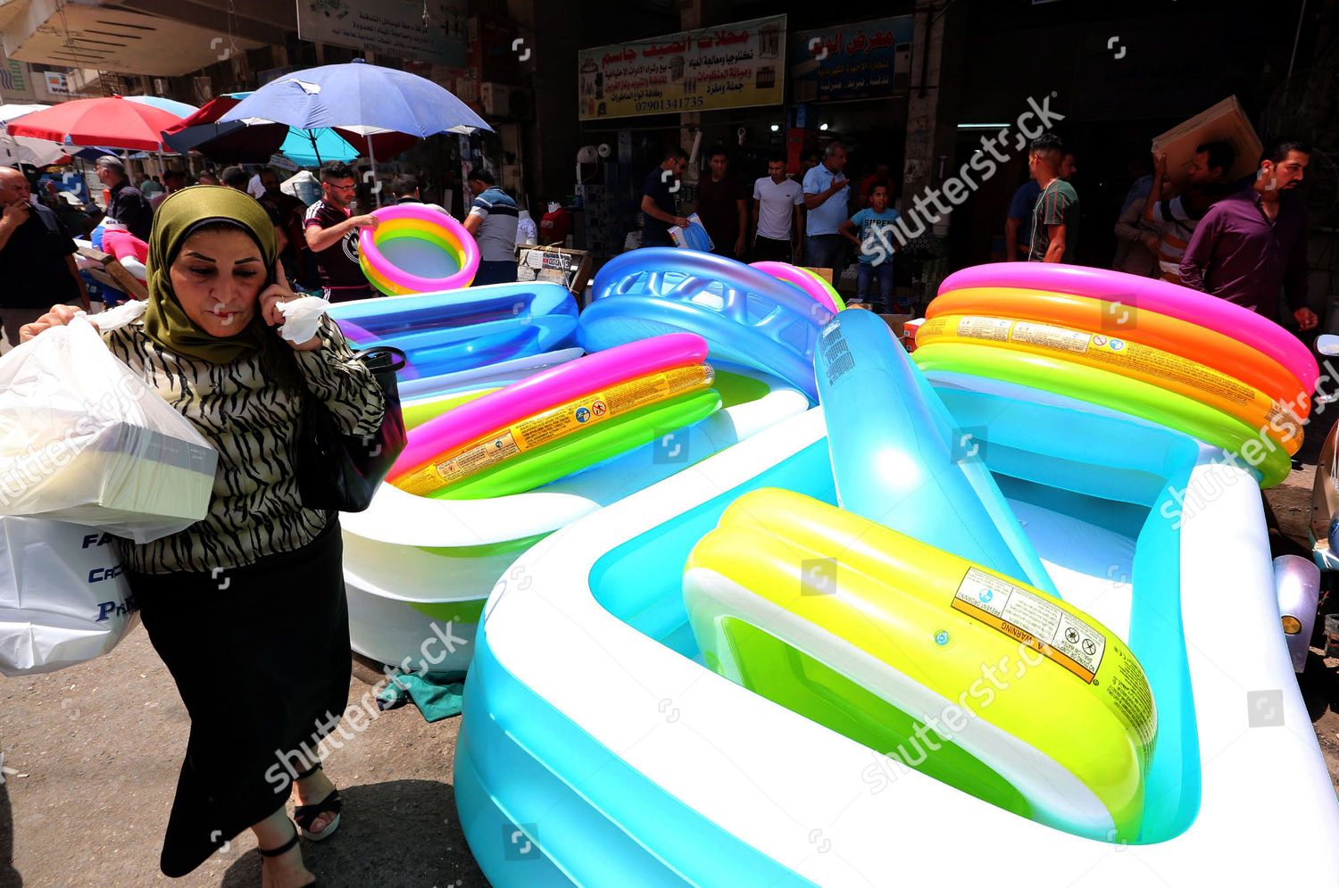 IRAQI VENDOR DISPLAYS RUBBER SWIMMING POOLS Editorial Stock Photo ...